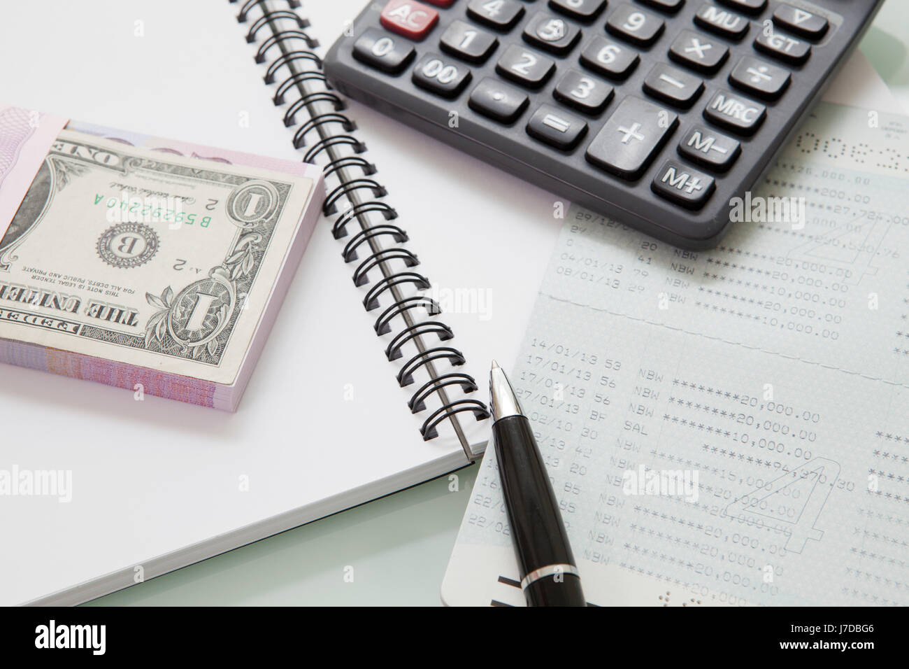 stack of bank note and pen calculator on note book use for business and ...