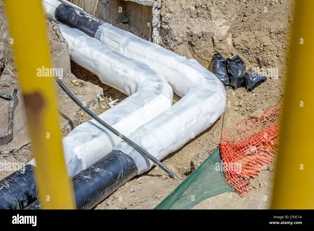 Placing set of thermal insulation on new pipeline in trench Stock Photo ...