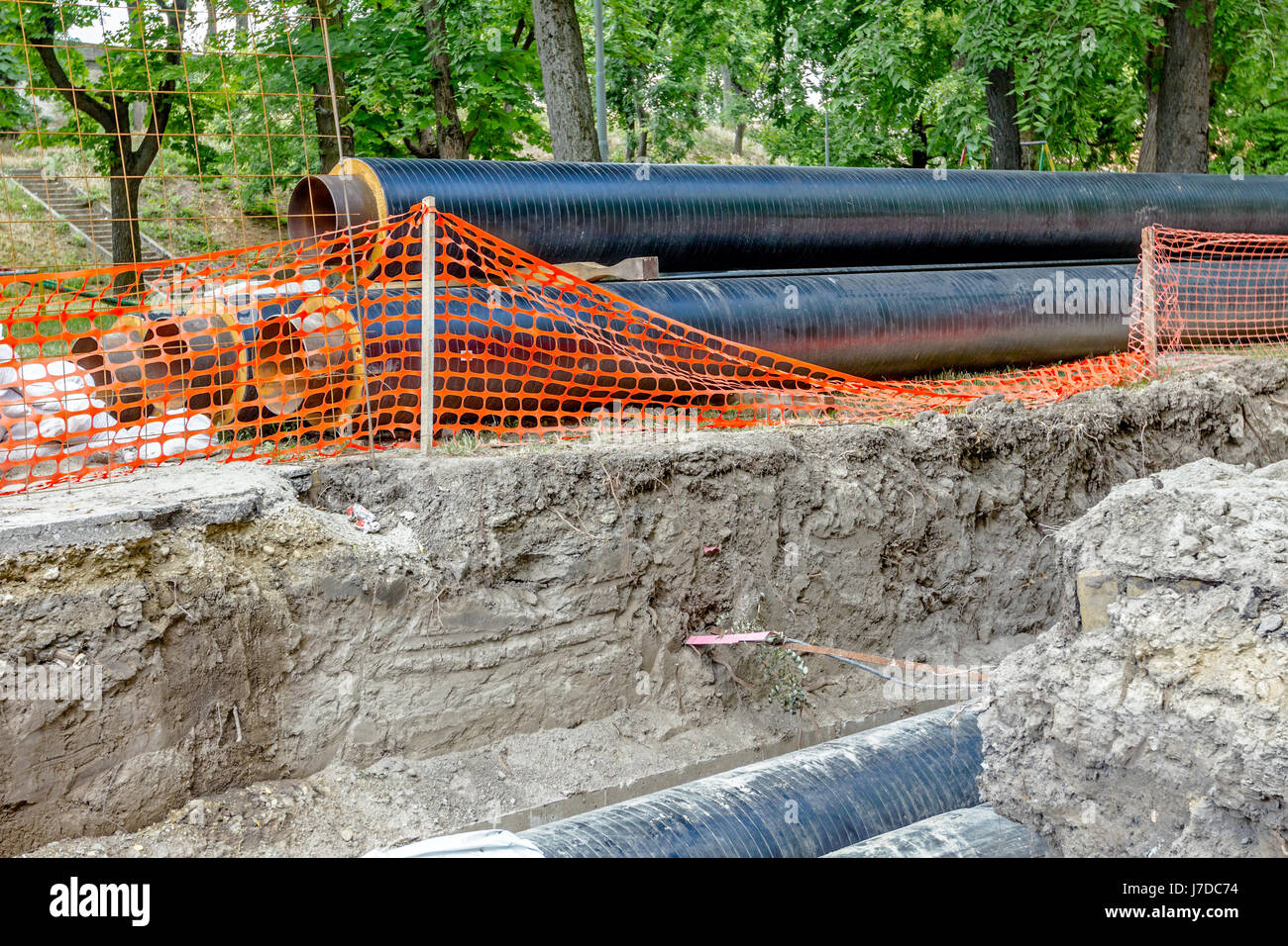 Confined space with orange, plastic, safety net is placed around the ...