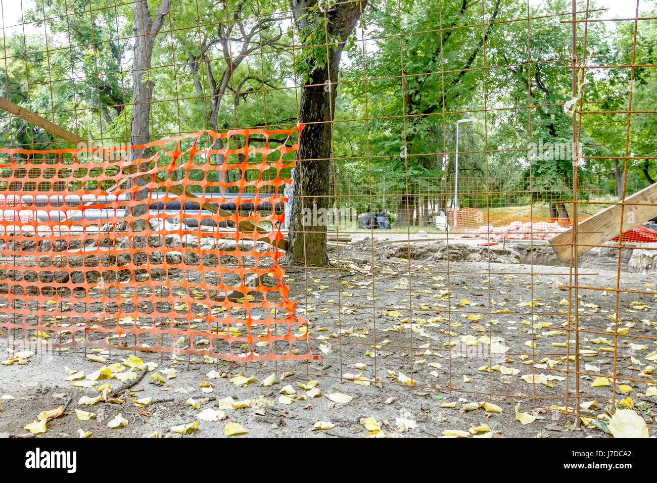 Confined space with orange, plastic, safety net is placed around the ...