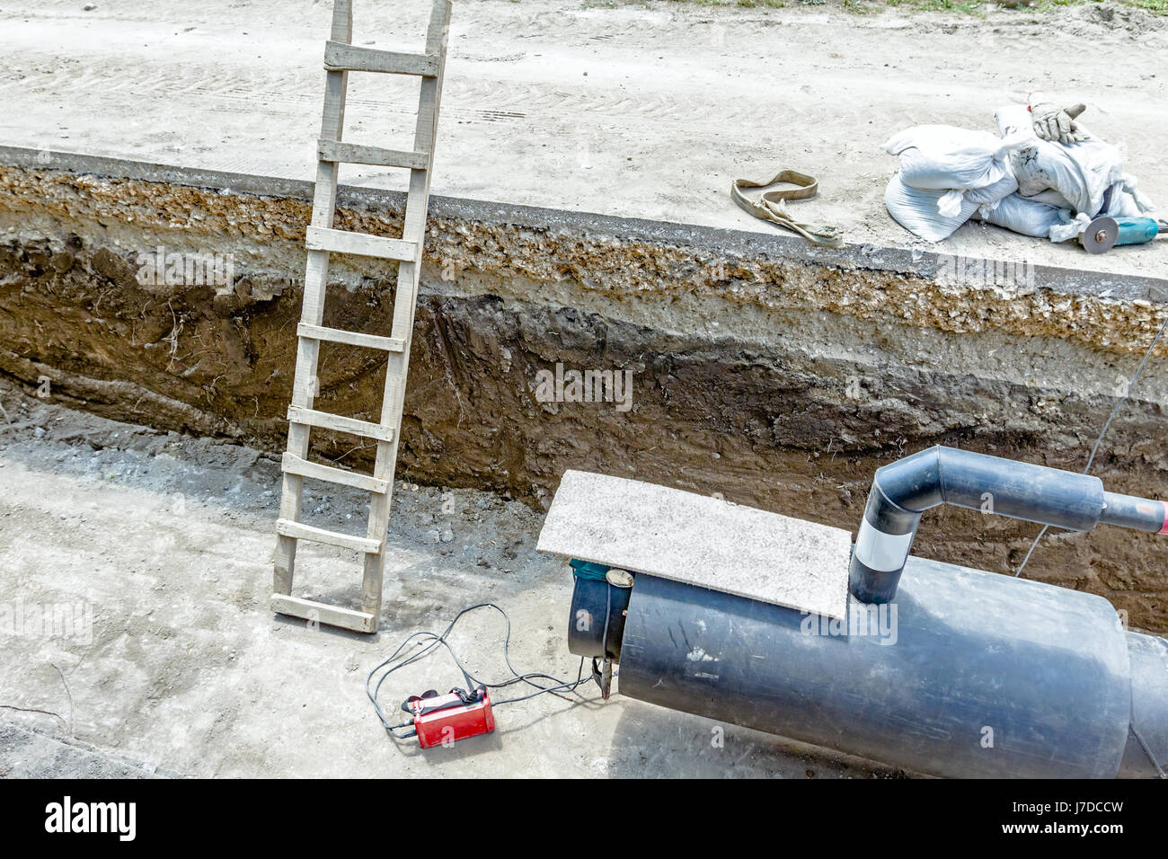 Wooden ladders are used for access into trench to welding pipeline ...