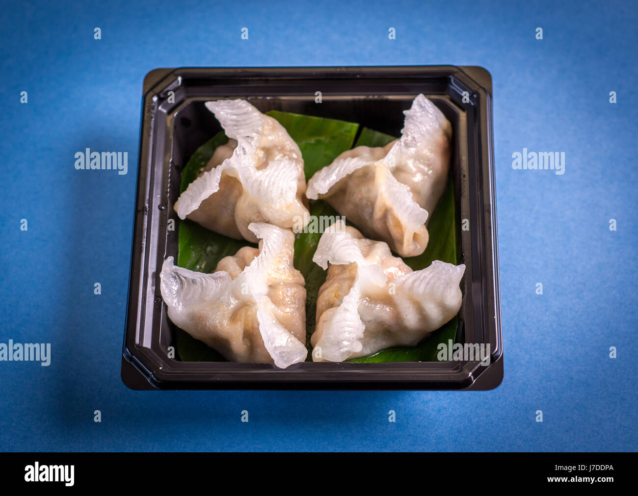 dim sum on a blue background Stock Photo - Alamy