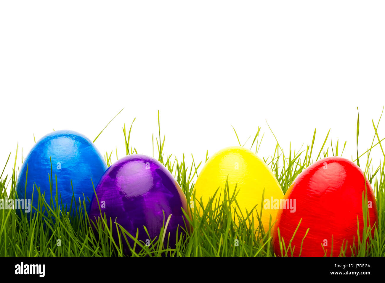 four easter eggs in grass colorful Stock Photo - Alamy