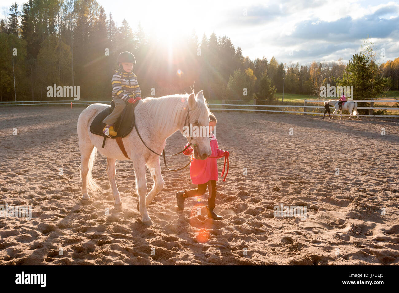 Little child riding with a pony Stock Photo - Alamy