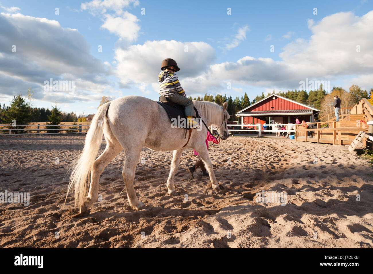 Little child riding with a pony Stock Photo - Alamy