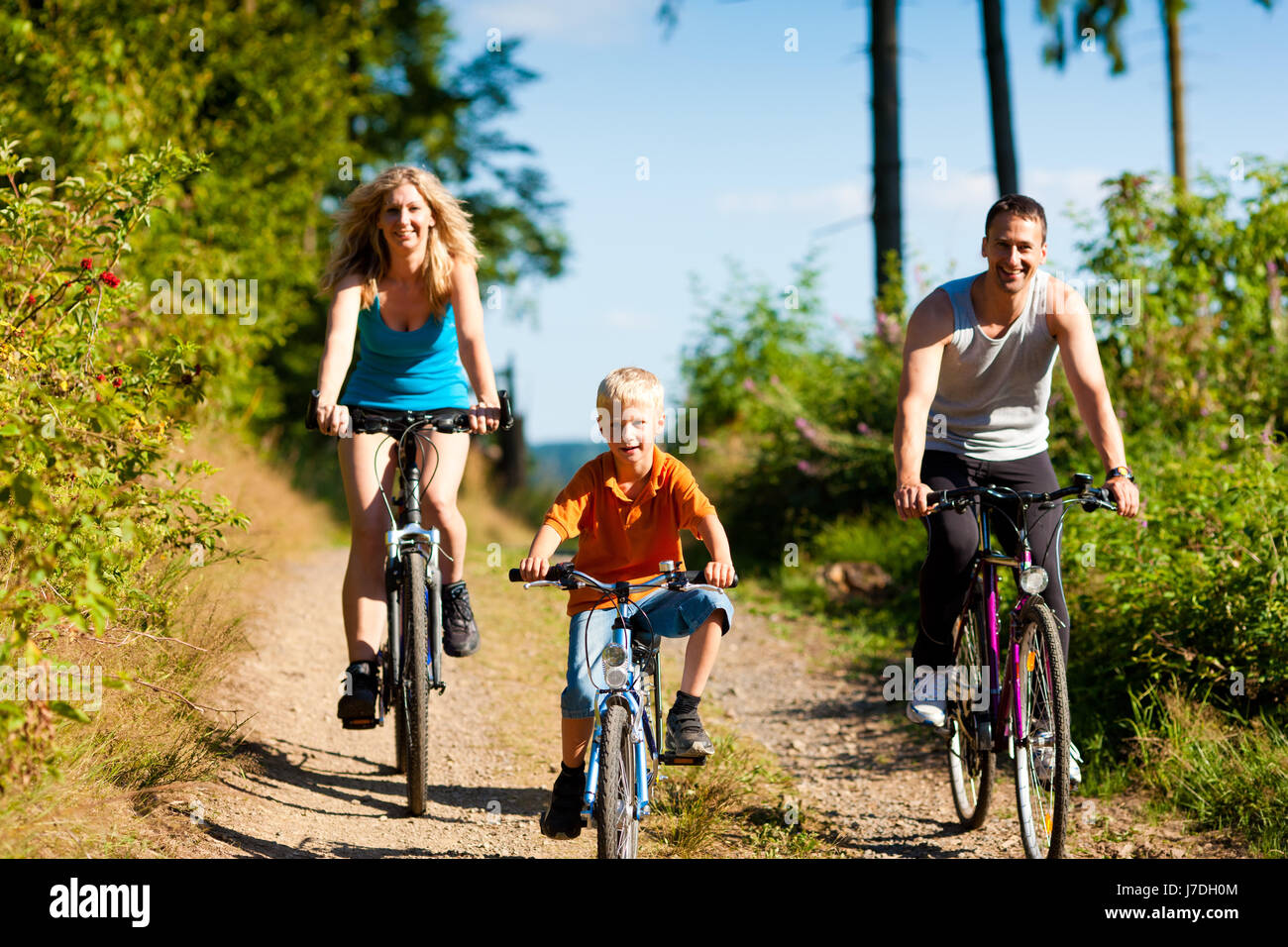 family rides a bike as a sport Stock Photo - Alamy