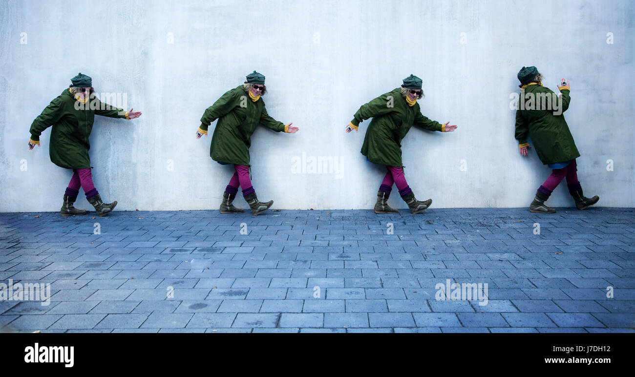 woman walks along the wall Stock Photo - Alamy