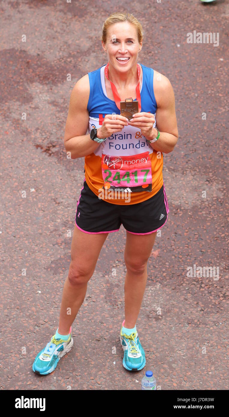 British professional rower, Helen Glover holds up her medal at the ...