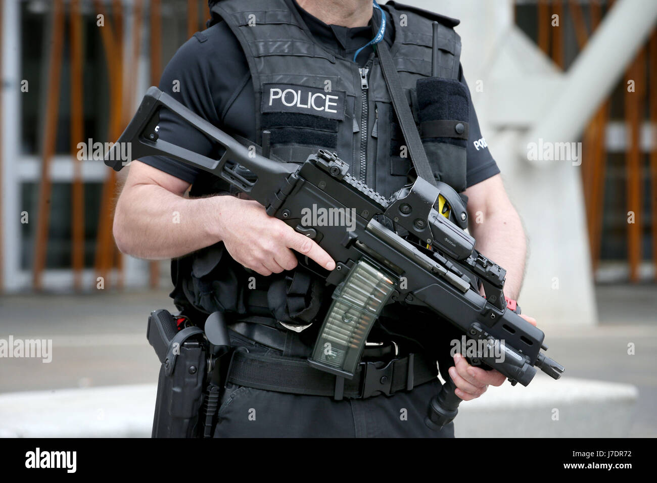 Armed police on patrol outside the Scottish Parliament building in ...