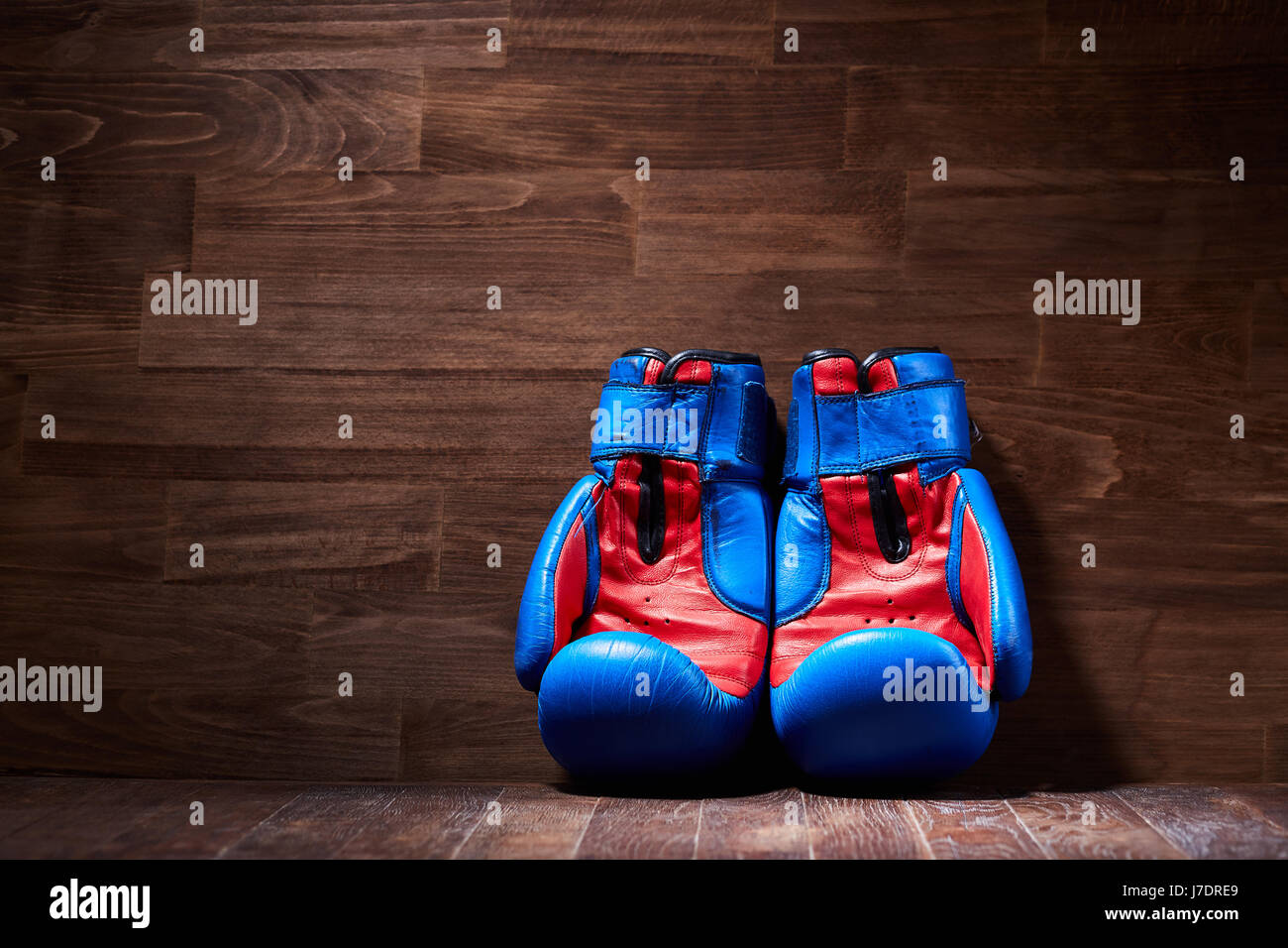 Boxing background with two gloves on the brown plank background ...