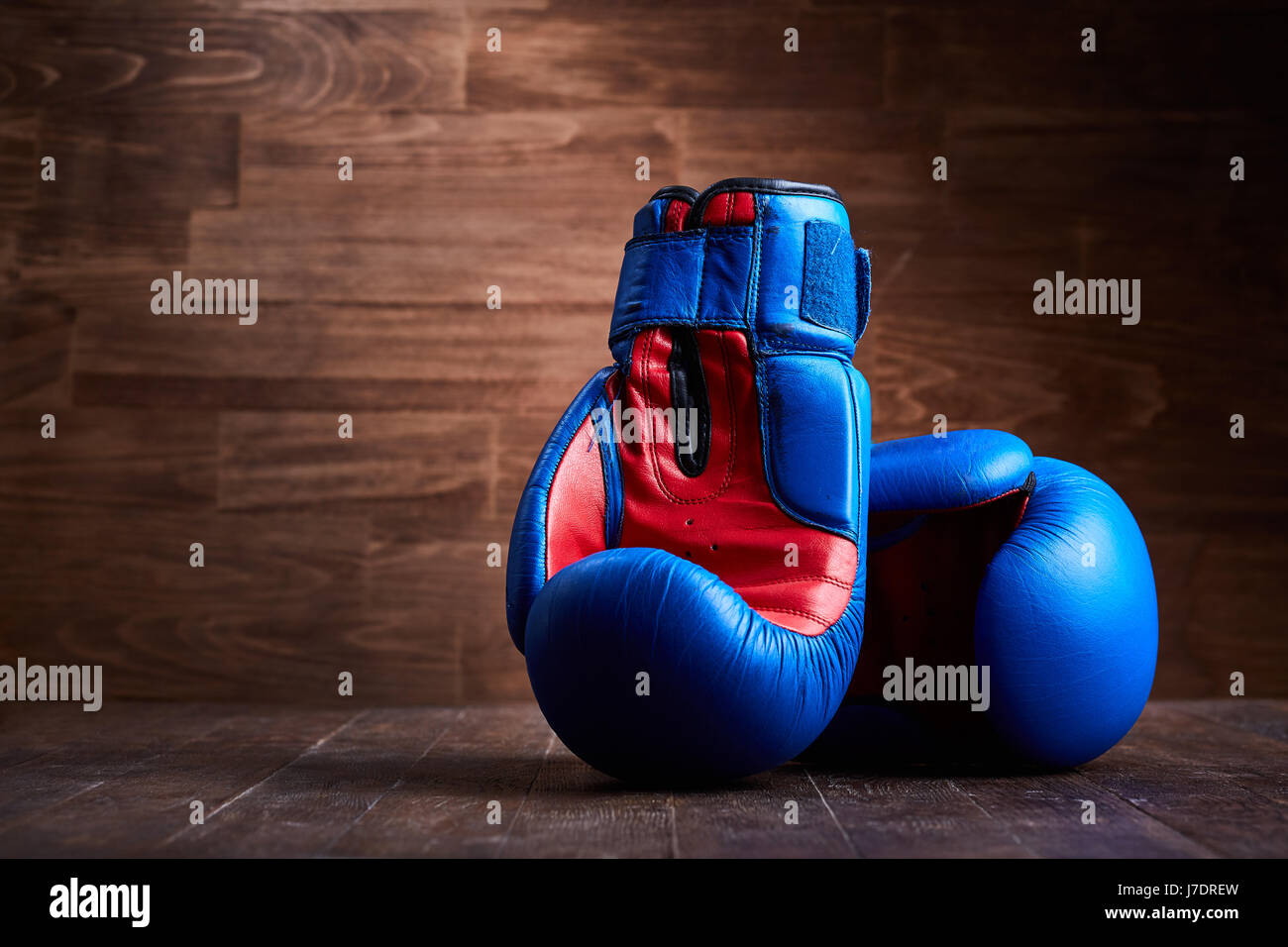 Boxing background with two gloves on the brown plank background ...