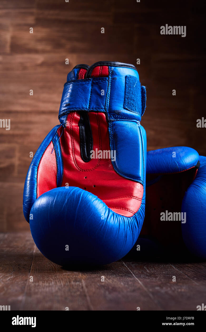 Boxing backgrounds with two blue and red gloves on the wooden plank ...