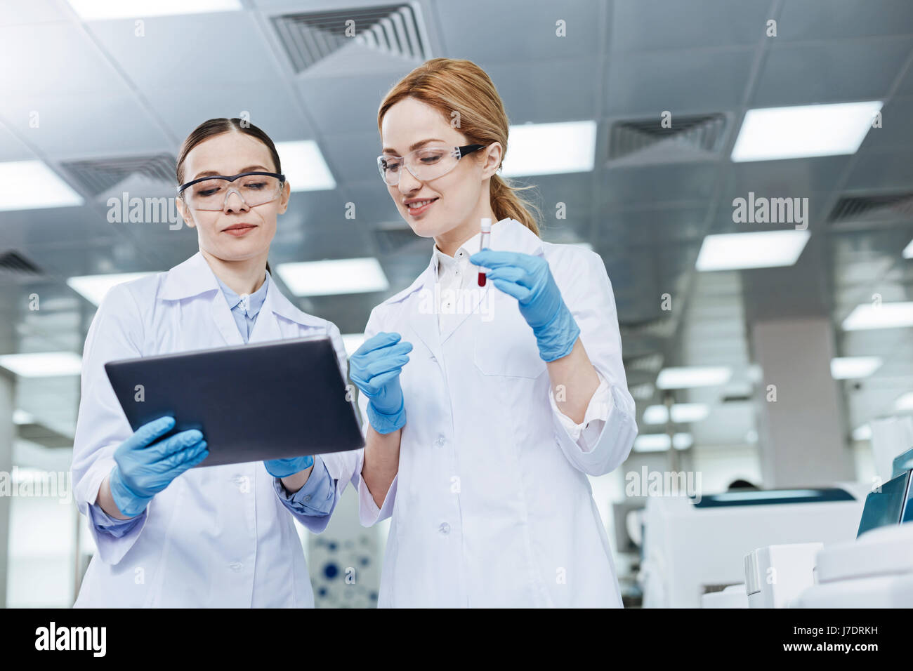 Positive delighted lab assistants looking downwards Stock Photo - Alamy