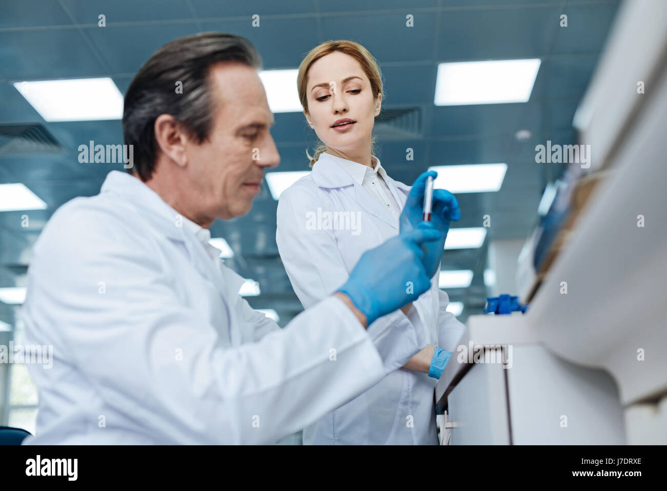 Attractive female medical worker looking at her colleague Stock Photo ...