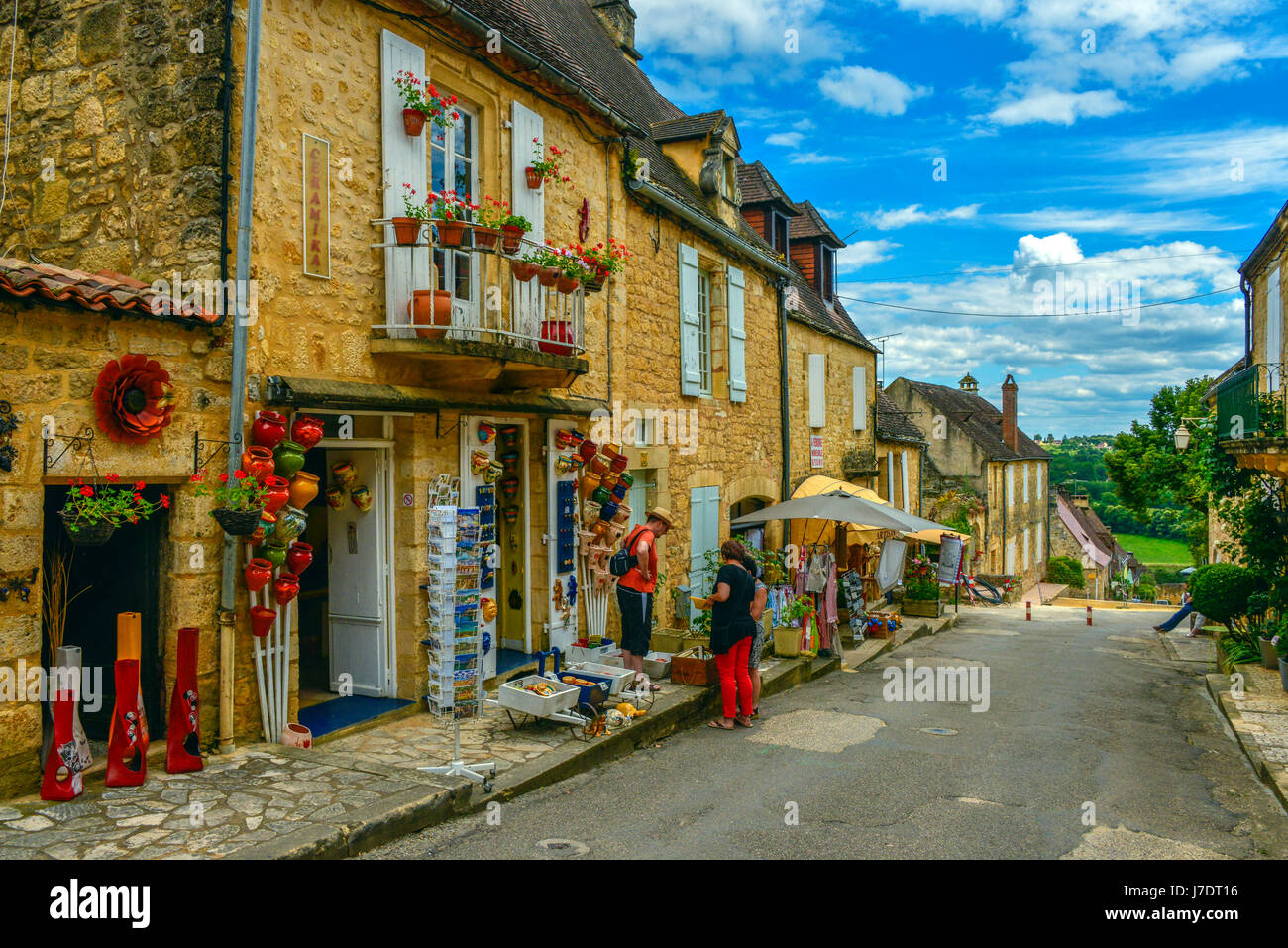 Village street scene with shops and homes, in the French hill top town ...