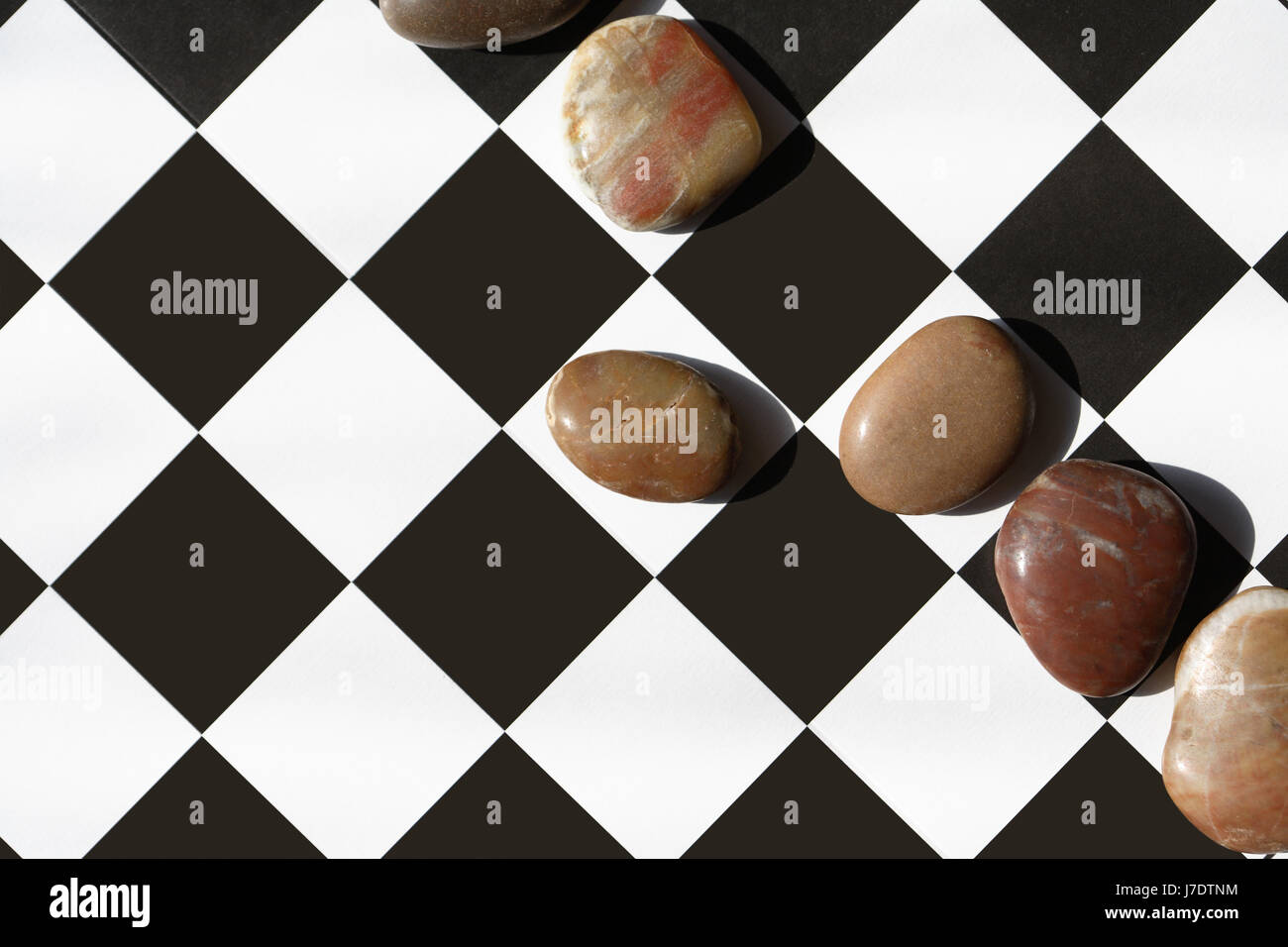 Strategy concept. Few stones lying in a row on chessboard Stock Photo ...