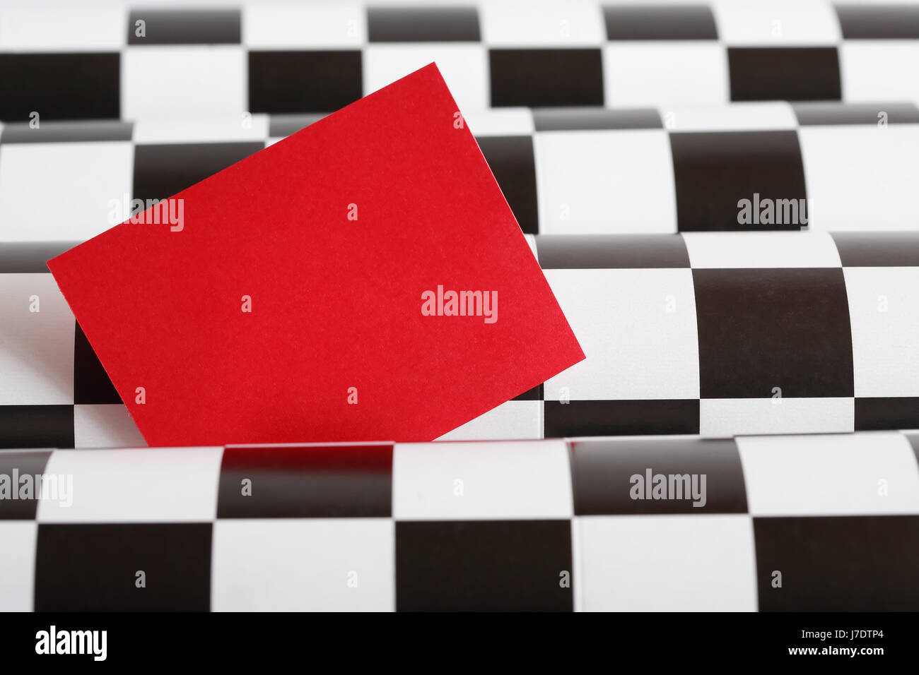 Blank red paper for text on black and white checkered background Stock ...