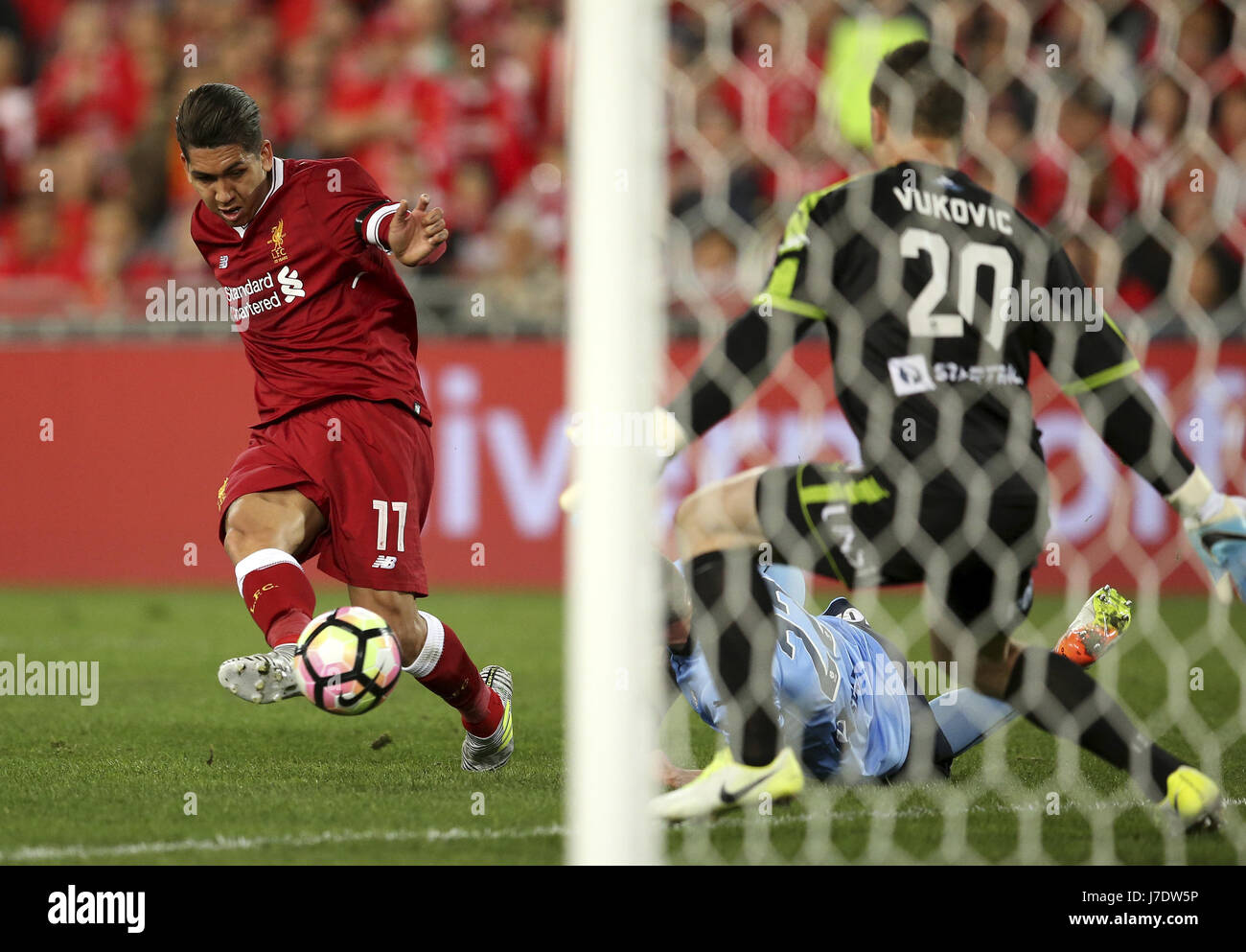 Liverpool FC's Roberto Firmino, left, has a shot on Sydney FC's Danny ...