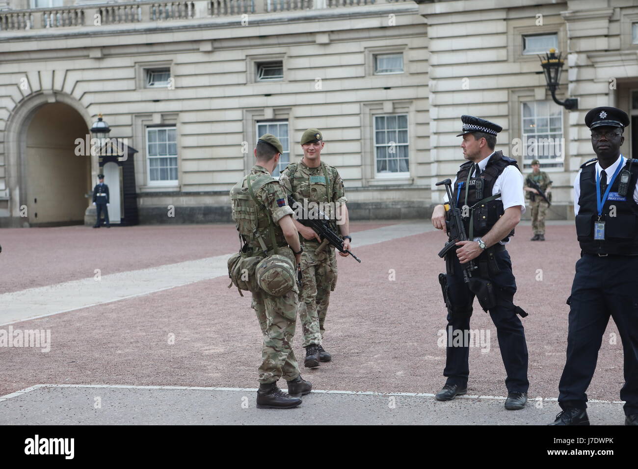 Soldiers join police officers outside Buckingham Palace, London, as ...