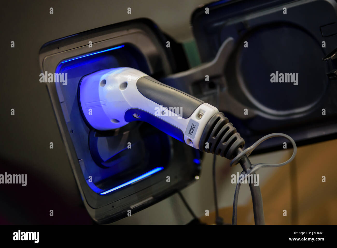 Power supply plugged into an electric car during charging Stock Photo ...