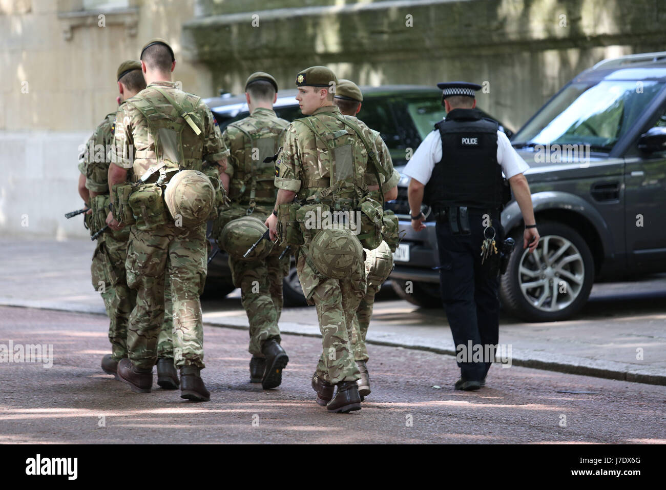 Soldiers join police officers outside Buckingham Palace, London, as ...