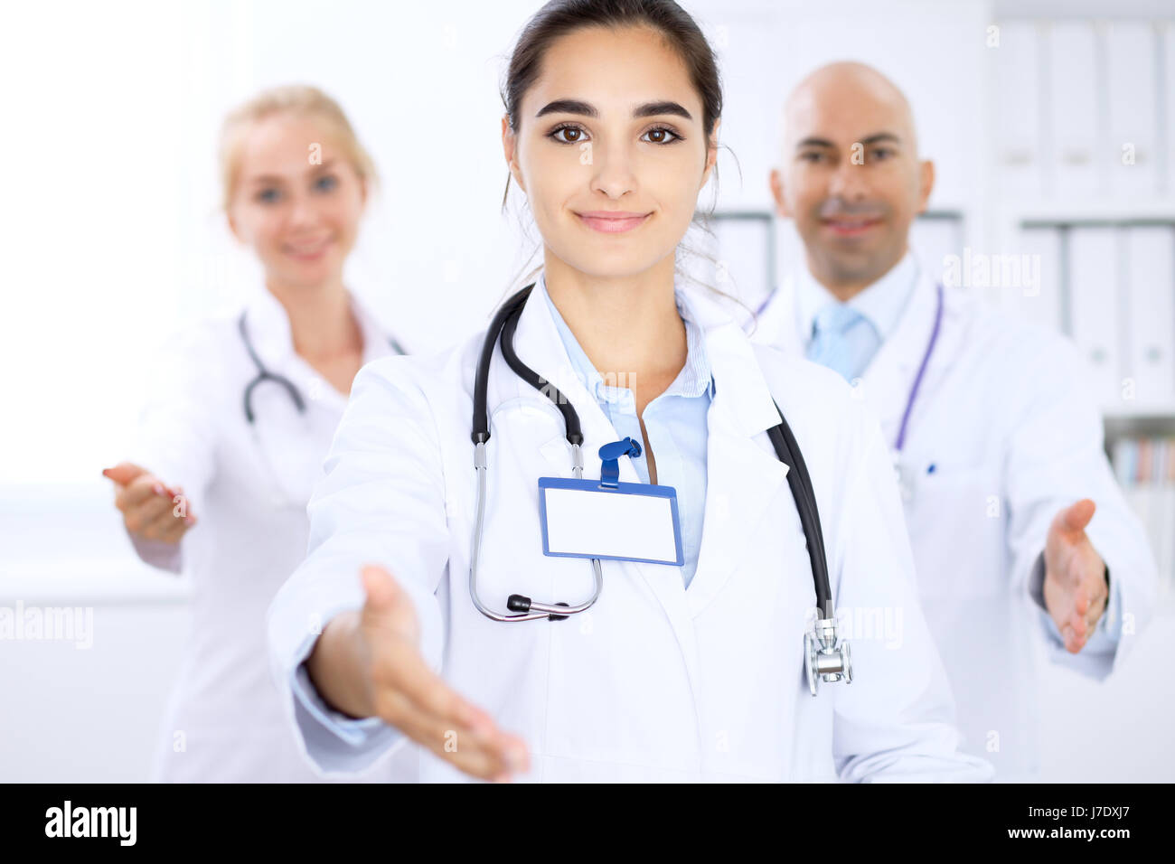 Happy doctor woman with medical staff at the hospital. Helping hand ...