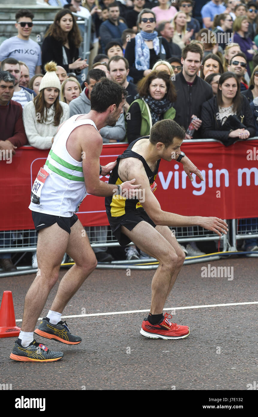 Matthew Rees (left) of Swansea Harriers unselfishly helps David Wyeth ...