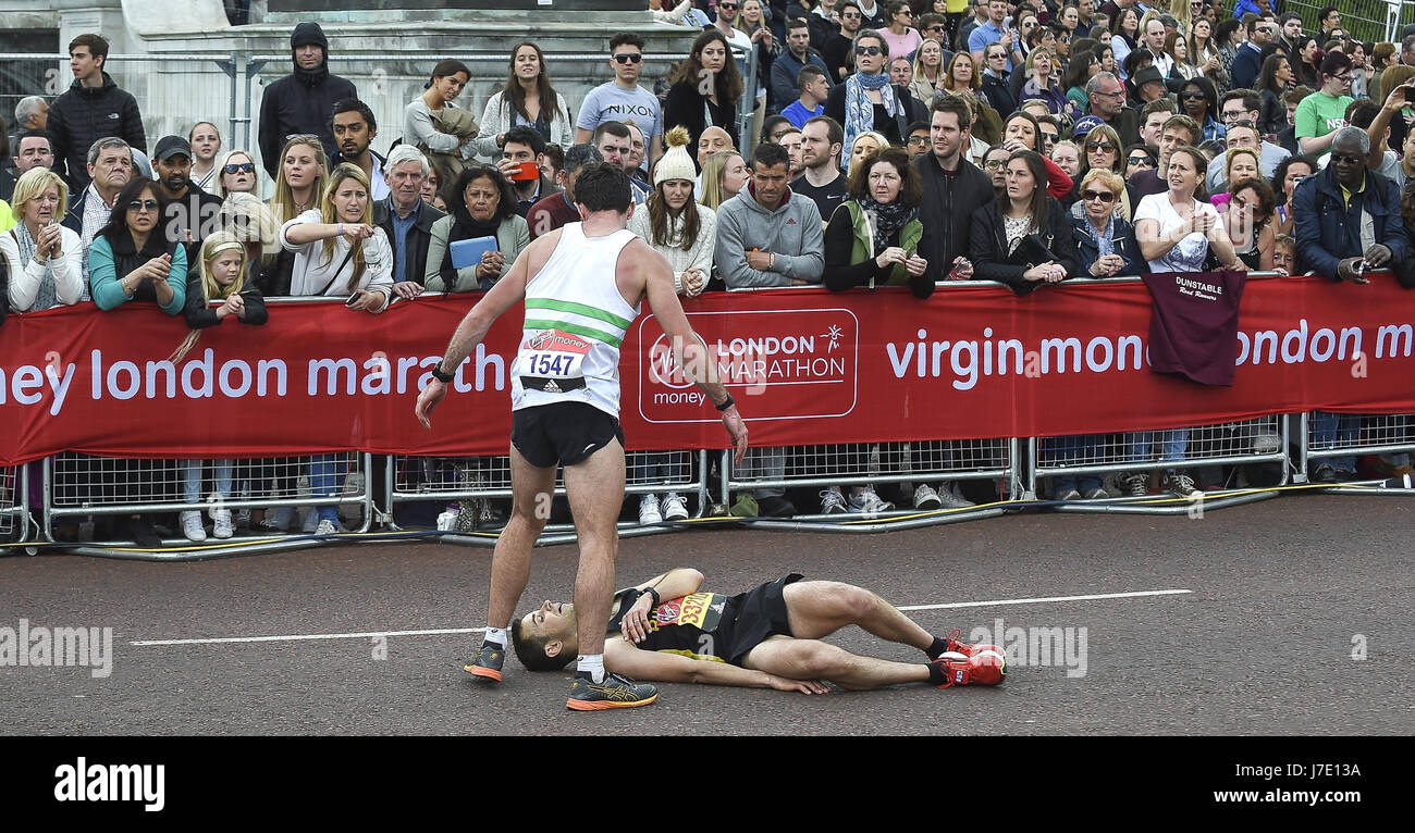 Matthew Rees (left) of Swansea Harriers unselfishly helps David Wyeth ...