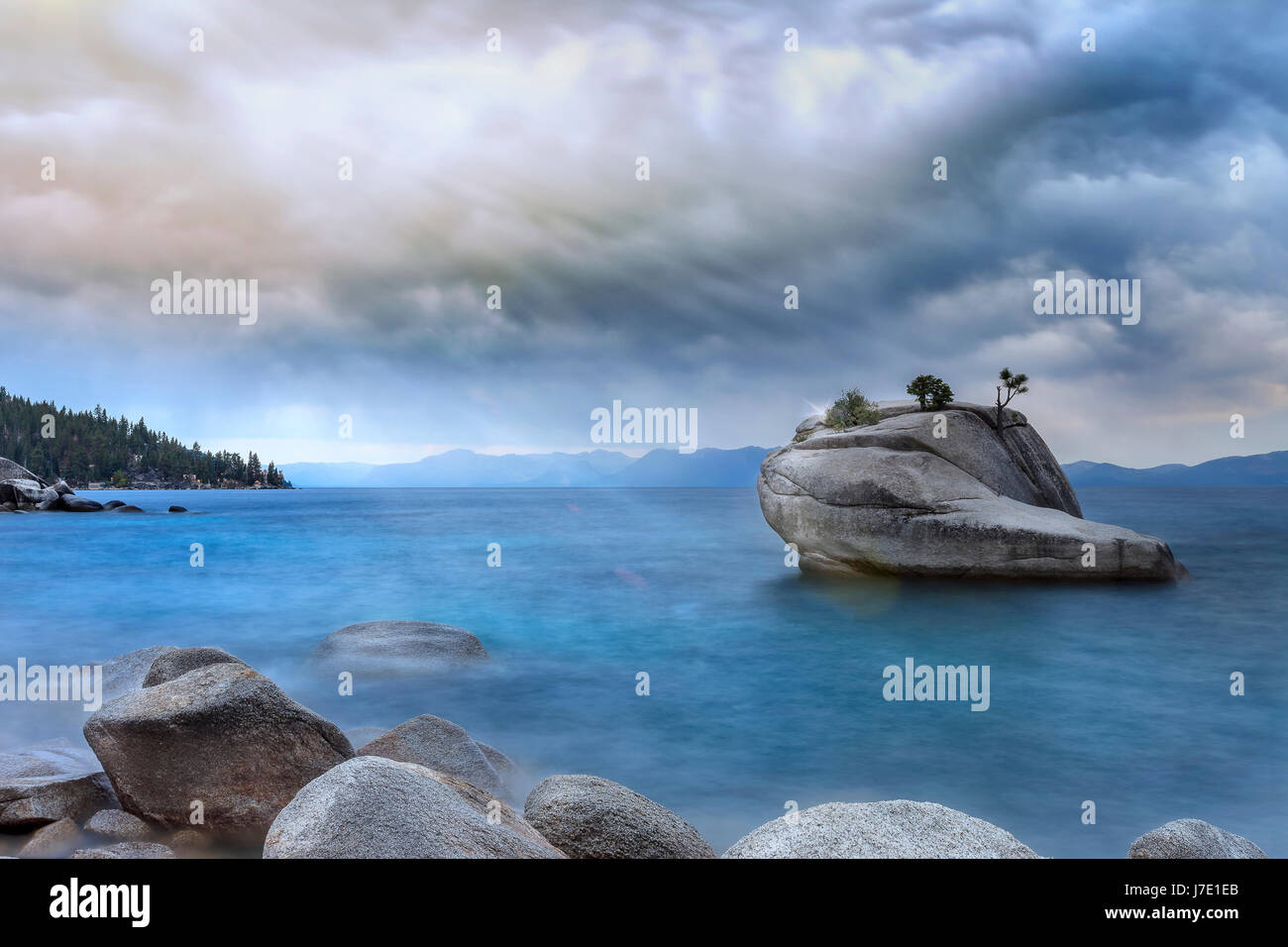 This is an image of Lake Tahoe during a summer storm. The large rock in ...