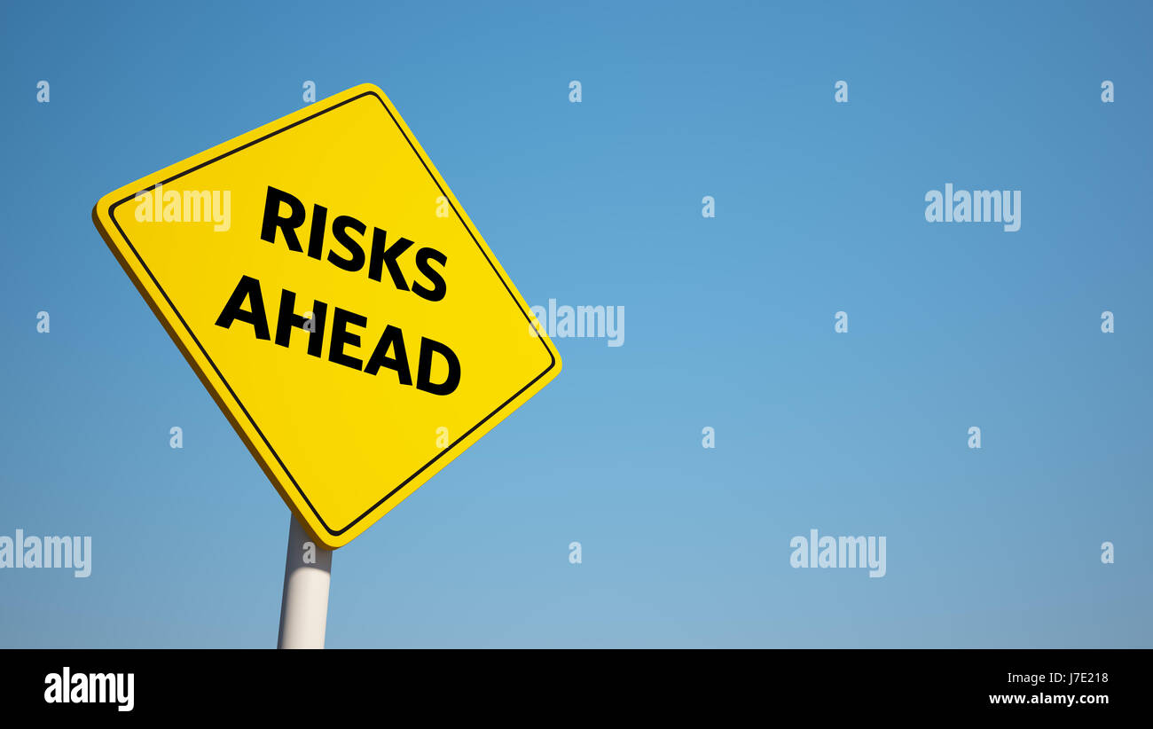 Risks Sign isolated on clean blue sky Stock Photo - Alamy