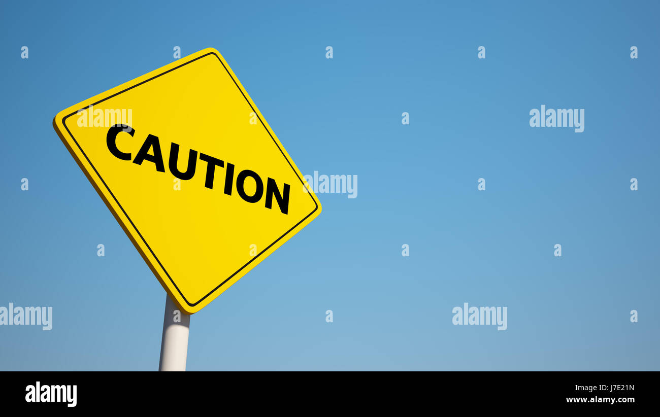 Caution Sign isolated on clean blue sky Stock Photo - Alamy