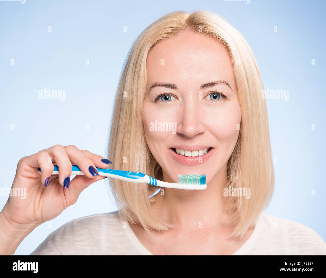 Blonde woman brush teeth hi-res stock photography and images - Alamy