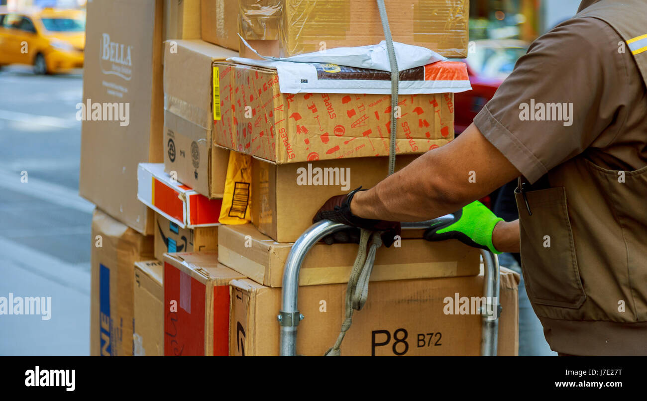 Young male deliverer with boxes outdoors Mail Stock Photo - Alamy