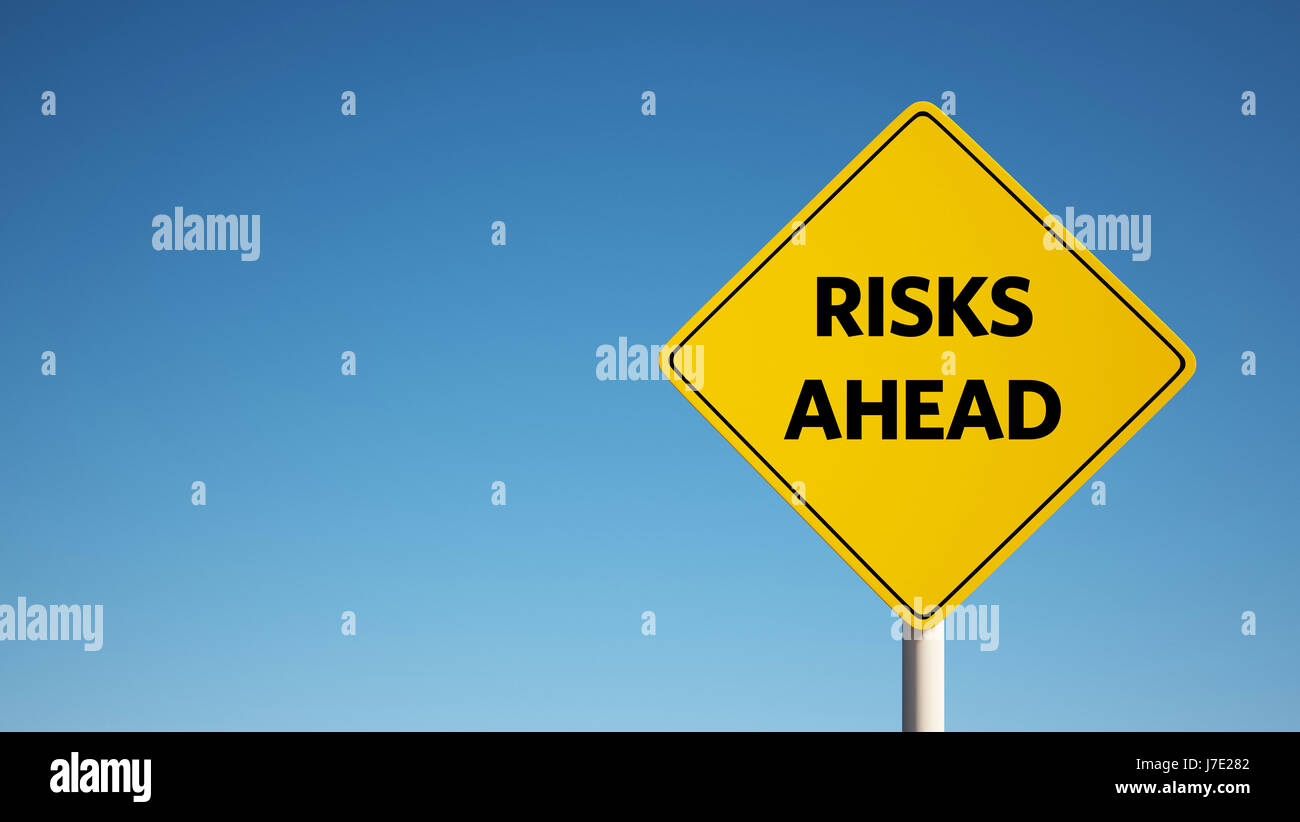 Risks Sign isolated on clean blue sky Stock Photo - Alamy