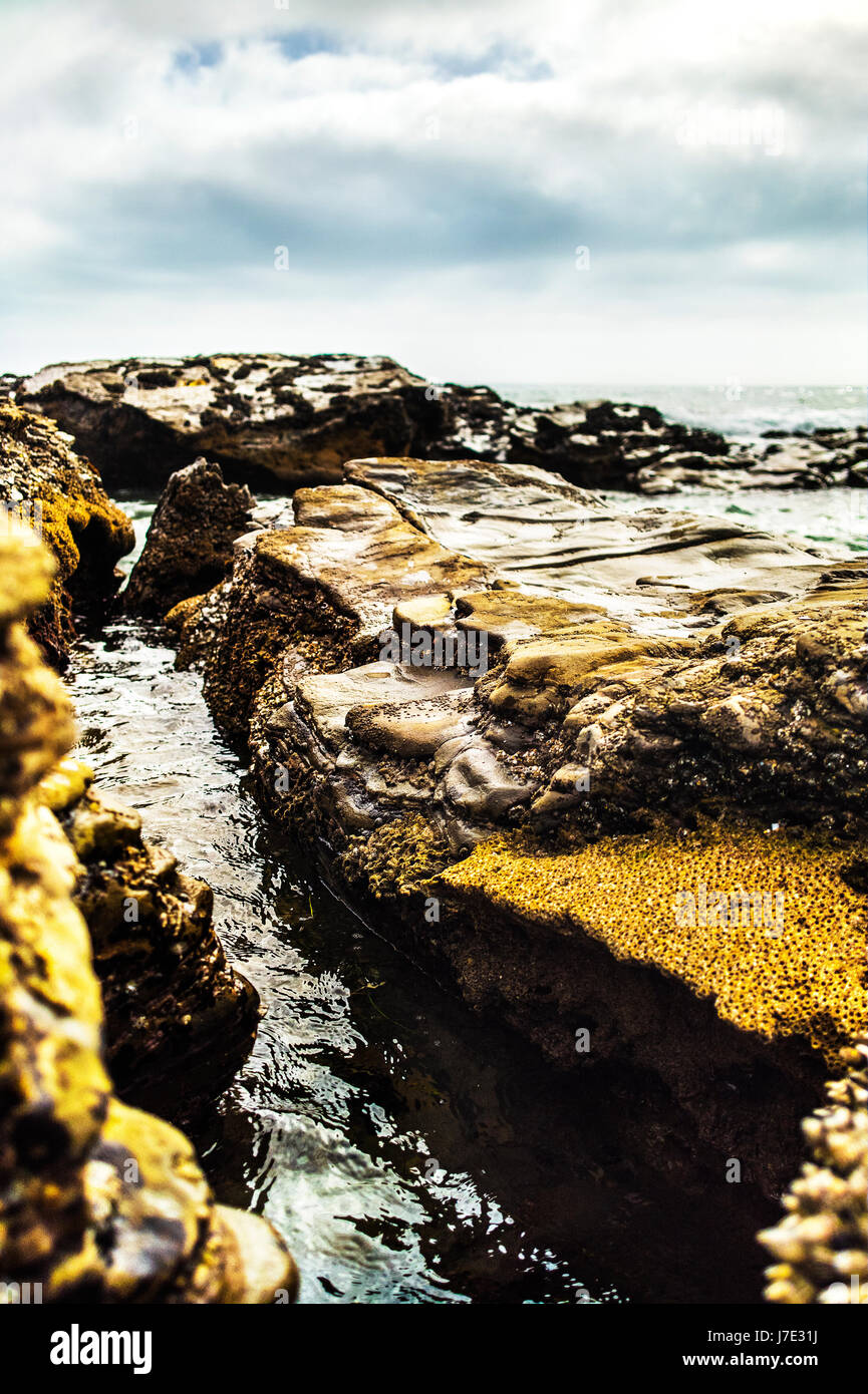 Rock wall formation on a gloomy sky Stock Photo - Alamy