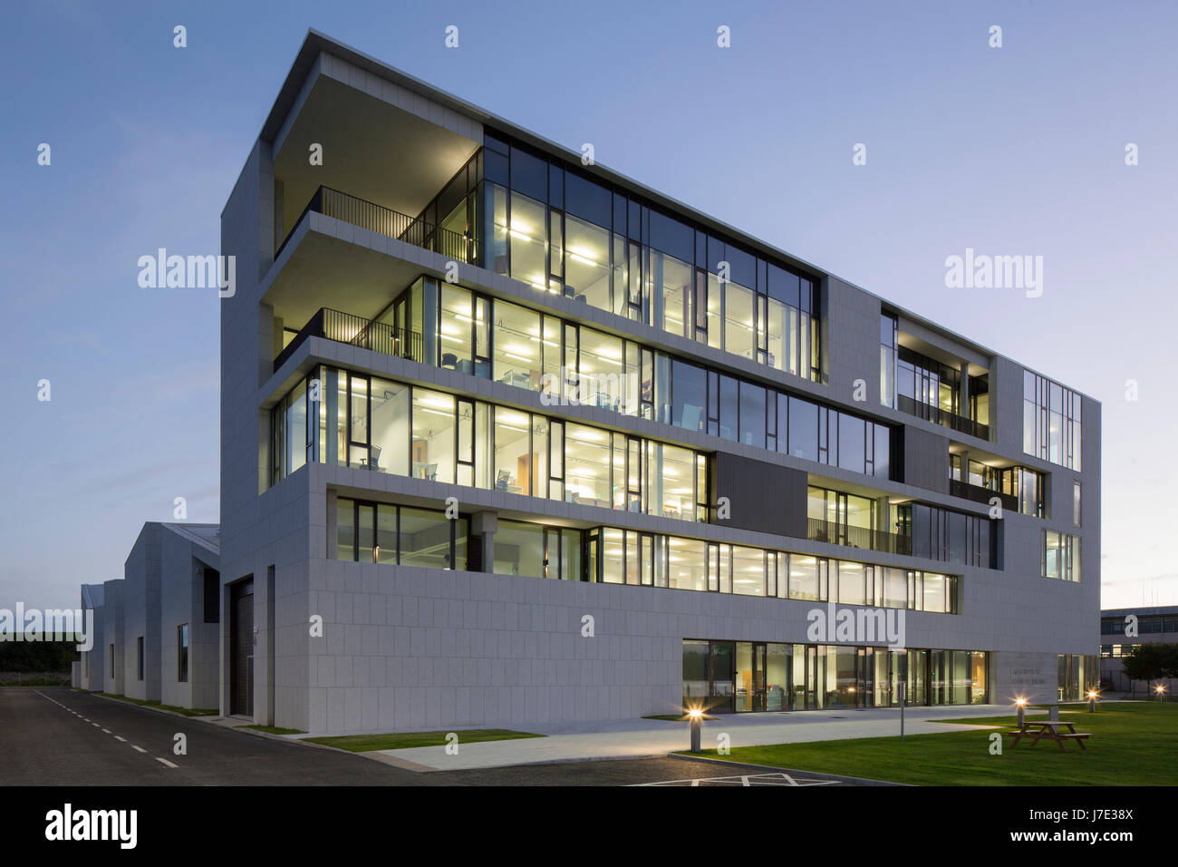 Corner elevation of research space and lower tank halls at dusk ...