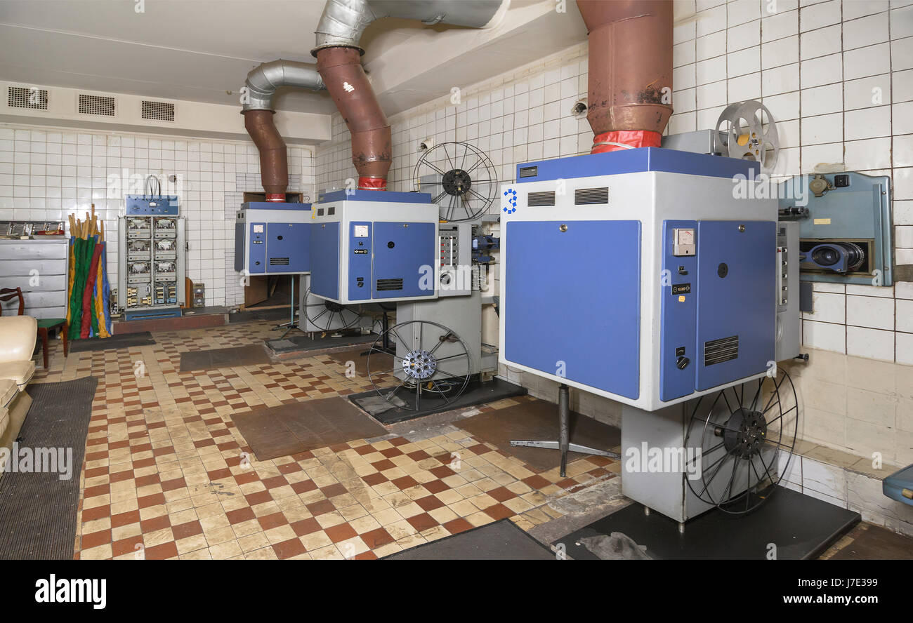 Projection room with large film projectors in an old abandoned cinema ...