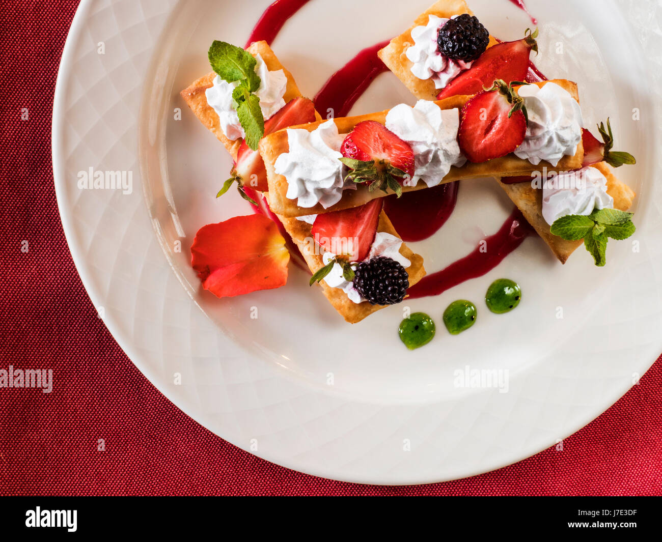 Puff pastry cookies, decorated with cream, strawberries and ...