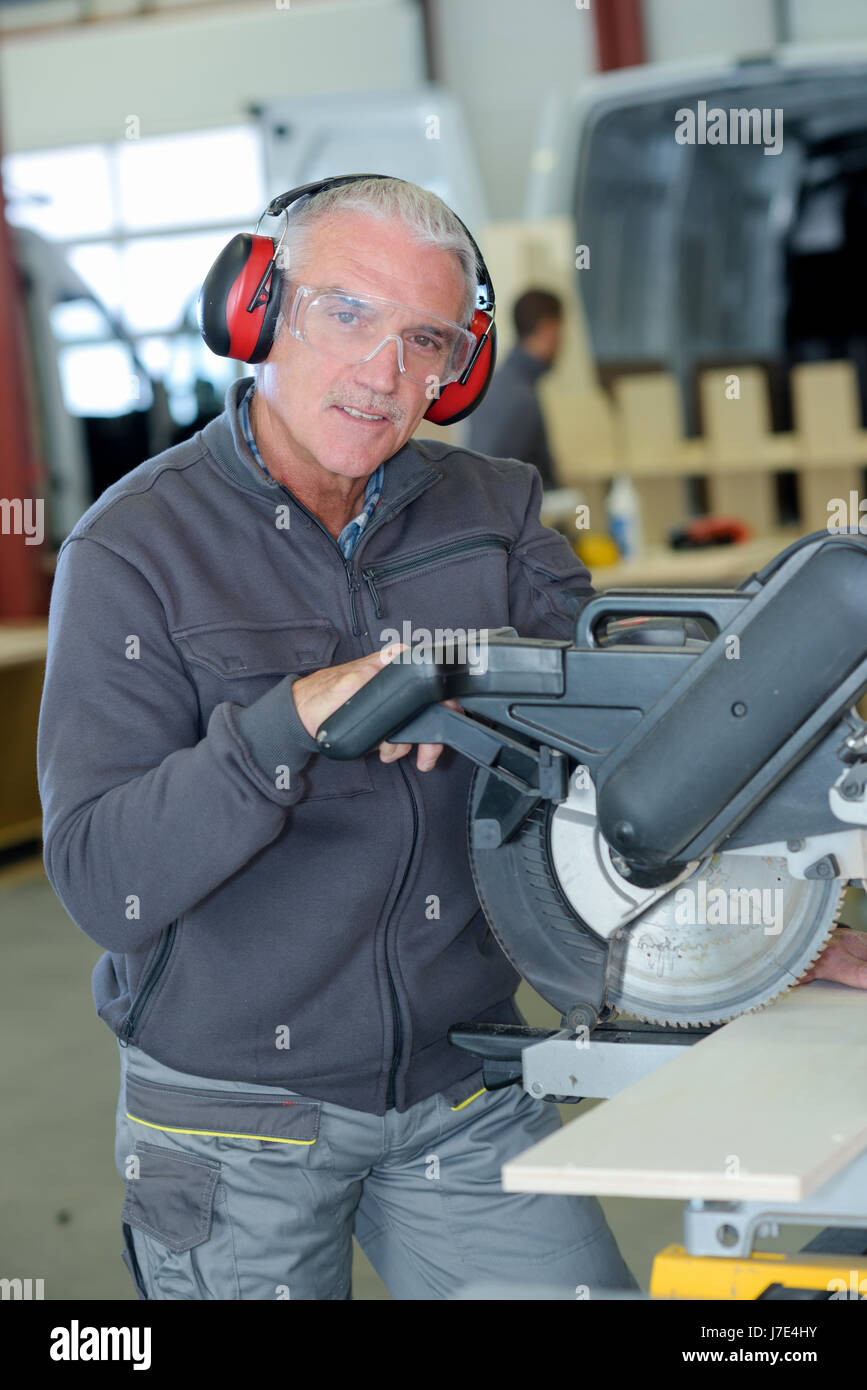 old man sawing with a circular saw Stock Photo - Alamy