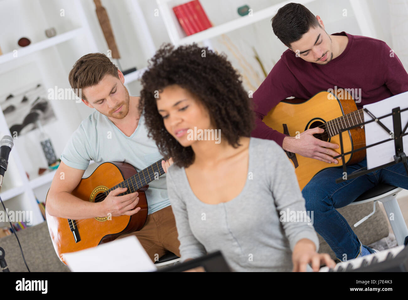 friends playing music indoors Stock Photo - Alamy
