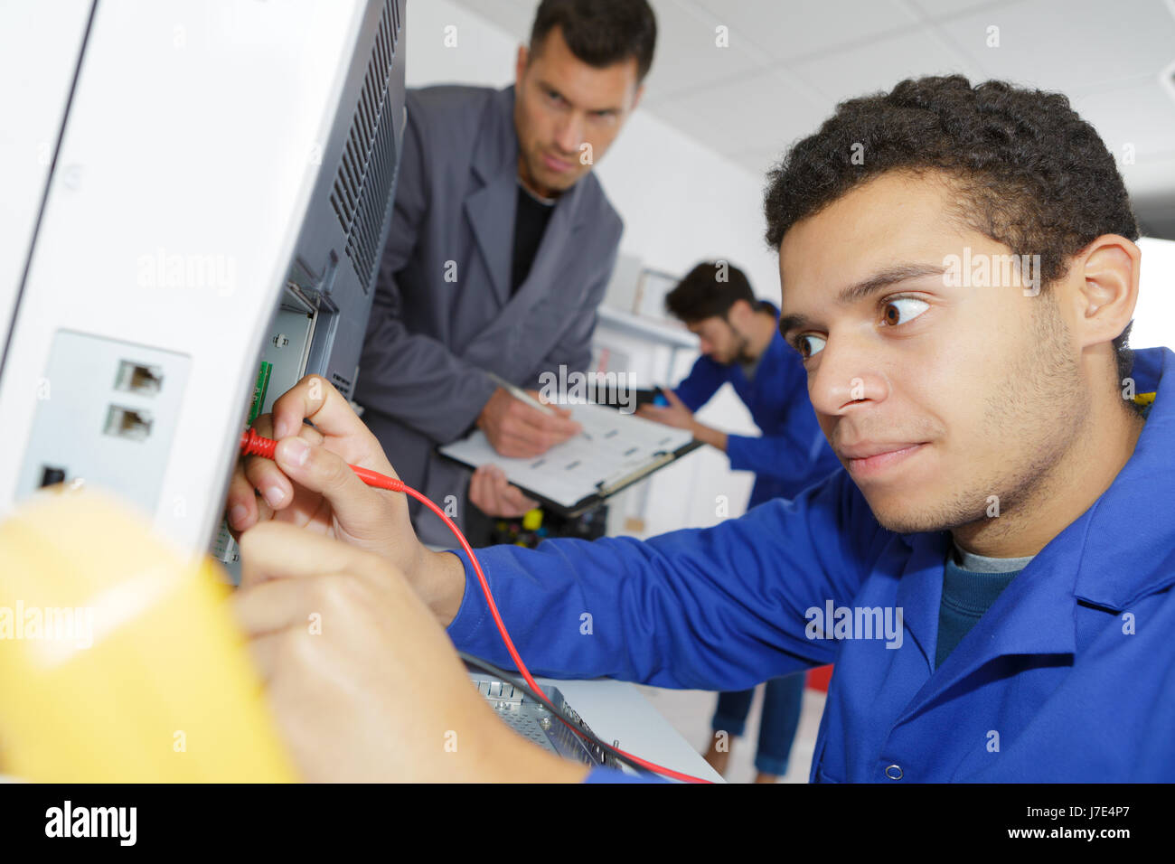 Young technician using multimeter Stock Photo - Alamy