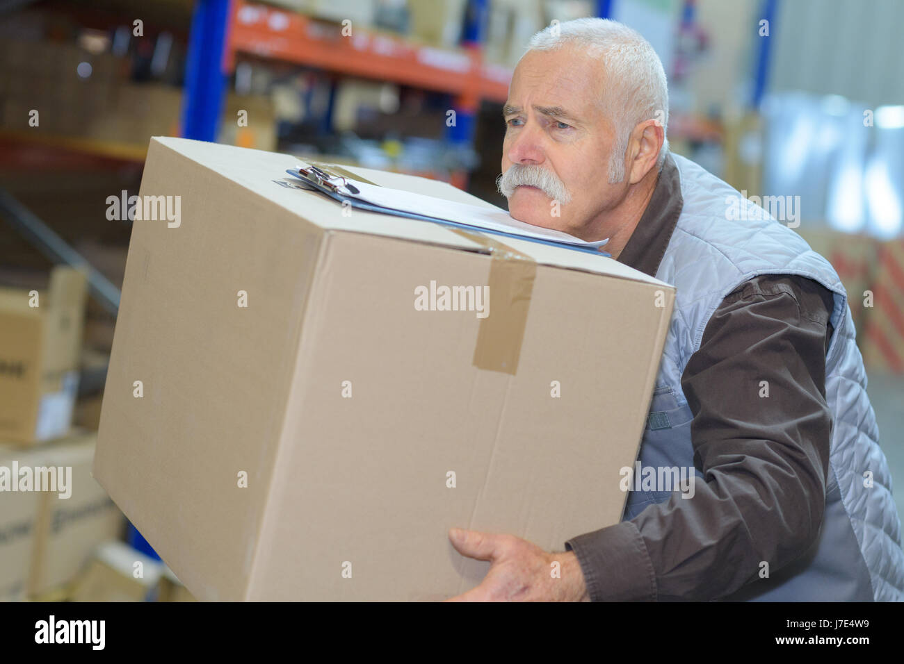 carrying a heavy box Stock Photo - Alamy