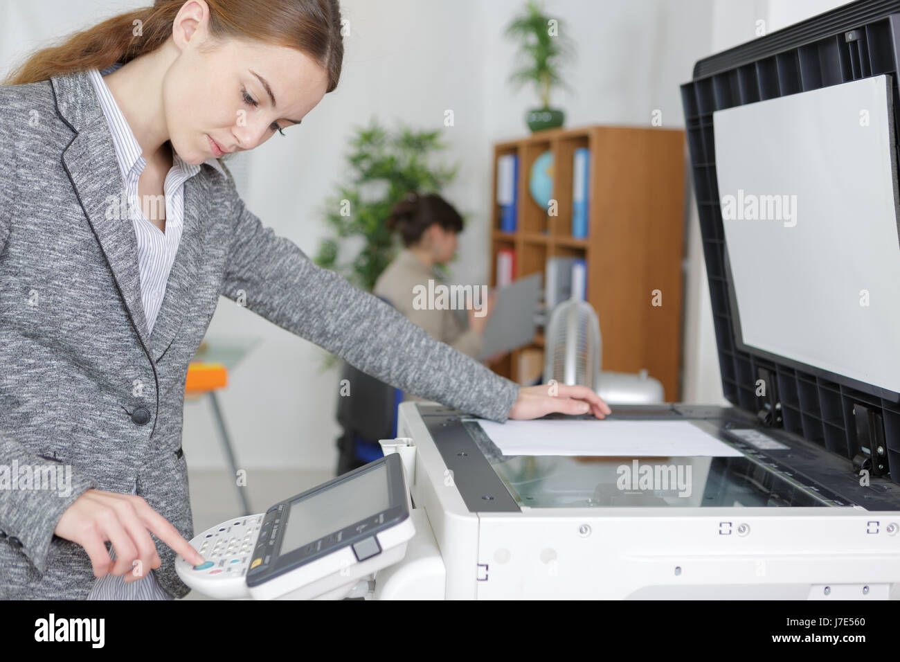 beautiful girl operating copier in modern office Stock Photo - Alamy
