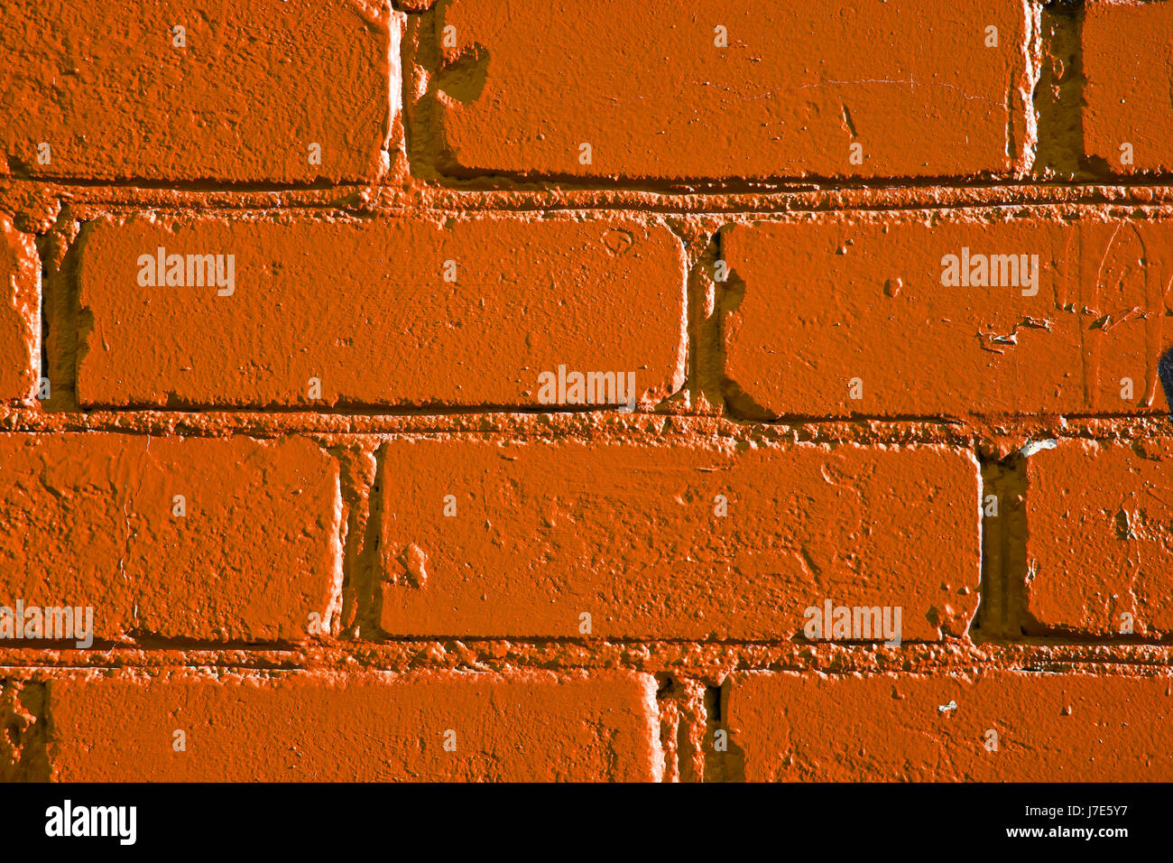 Brick wall painted in orange color Stock Photo - Alamy