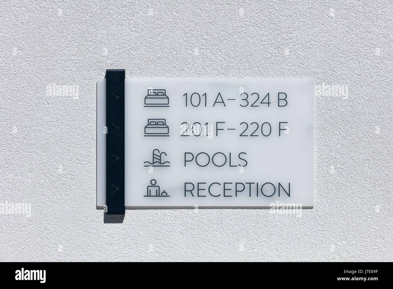 Hotel arrow signage on stone wall background. Lobby, Library ...