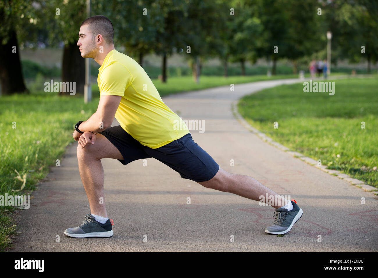 Fitness man stretching arm shoulder before outdoor workout. Sporty male ...