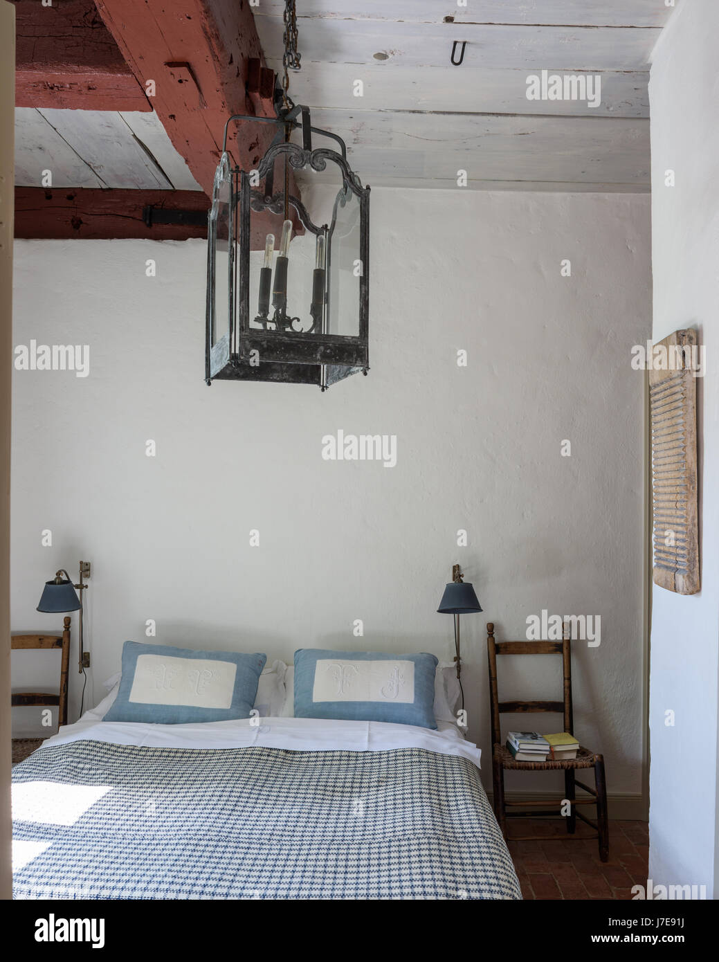 Lead lantern above monastic double bed with Welsh blanket Stock Photo ...