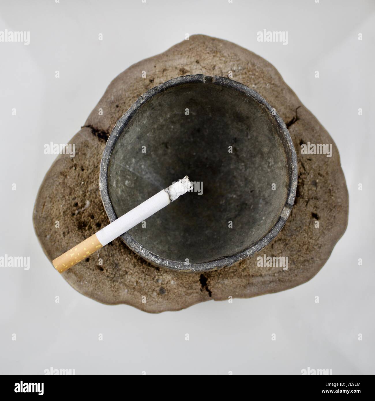 Handmade wooden coconut ashtray with a cigarette Stock Photo - Alamy