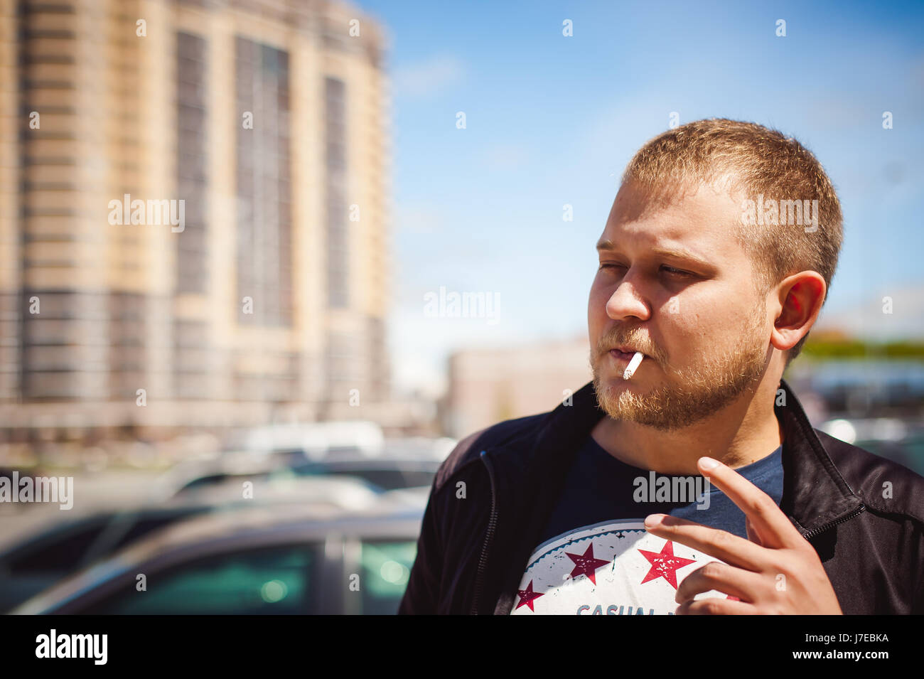 Portrait of a man with a beard with a mustache, smoking a cigarette ...