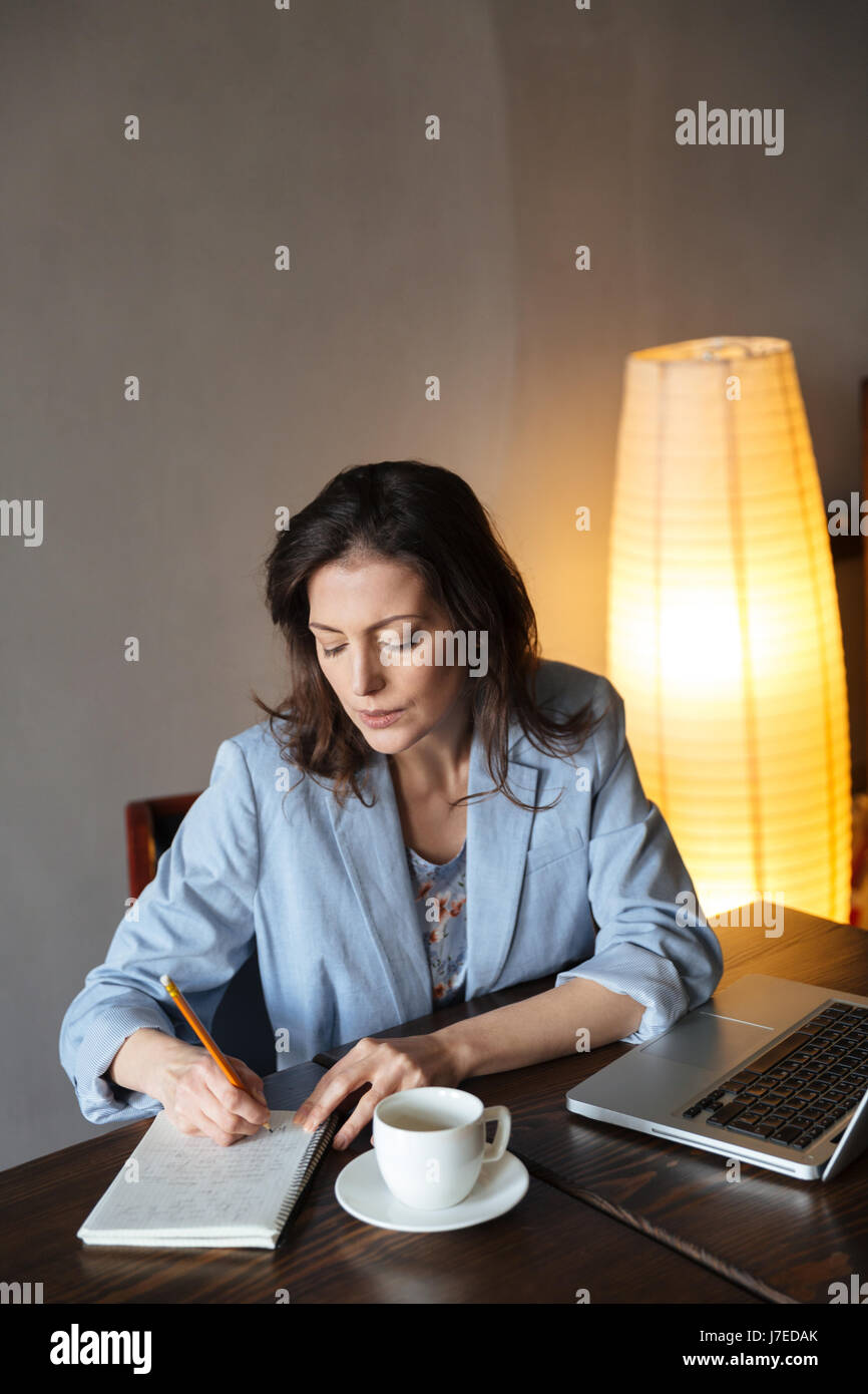 Picture of thinking woman writer sitting indoors using laptop computer ...